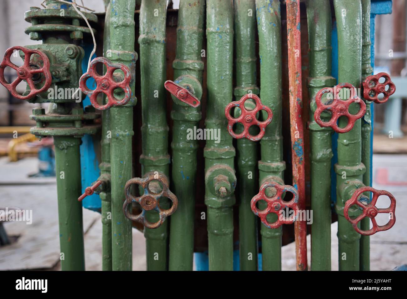 Close-up at pipeline valve which is using to control production process ...