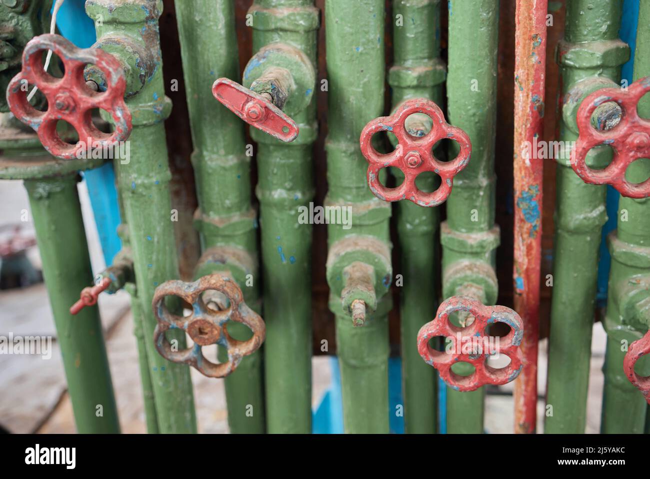 Close-up at pipeline valve which is using to control production process ...