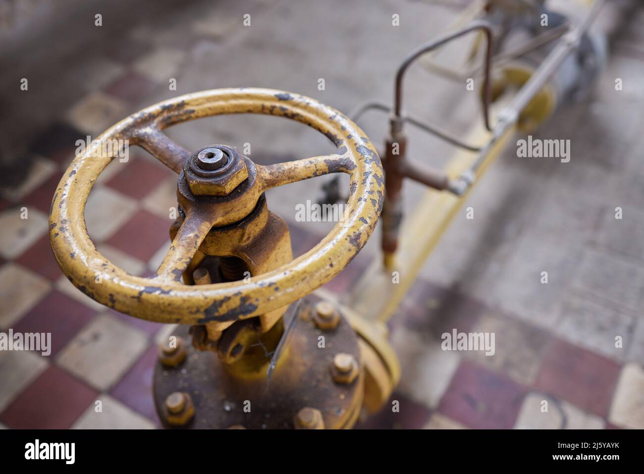 Close-up at pipeline valve which is using to control production process ...