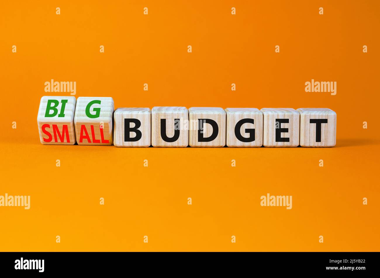 Big or small budget symbol. Turned wooden cubes and changed concept ...