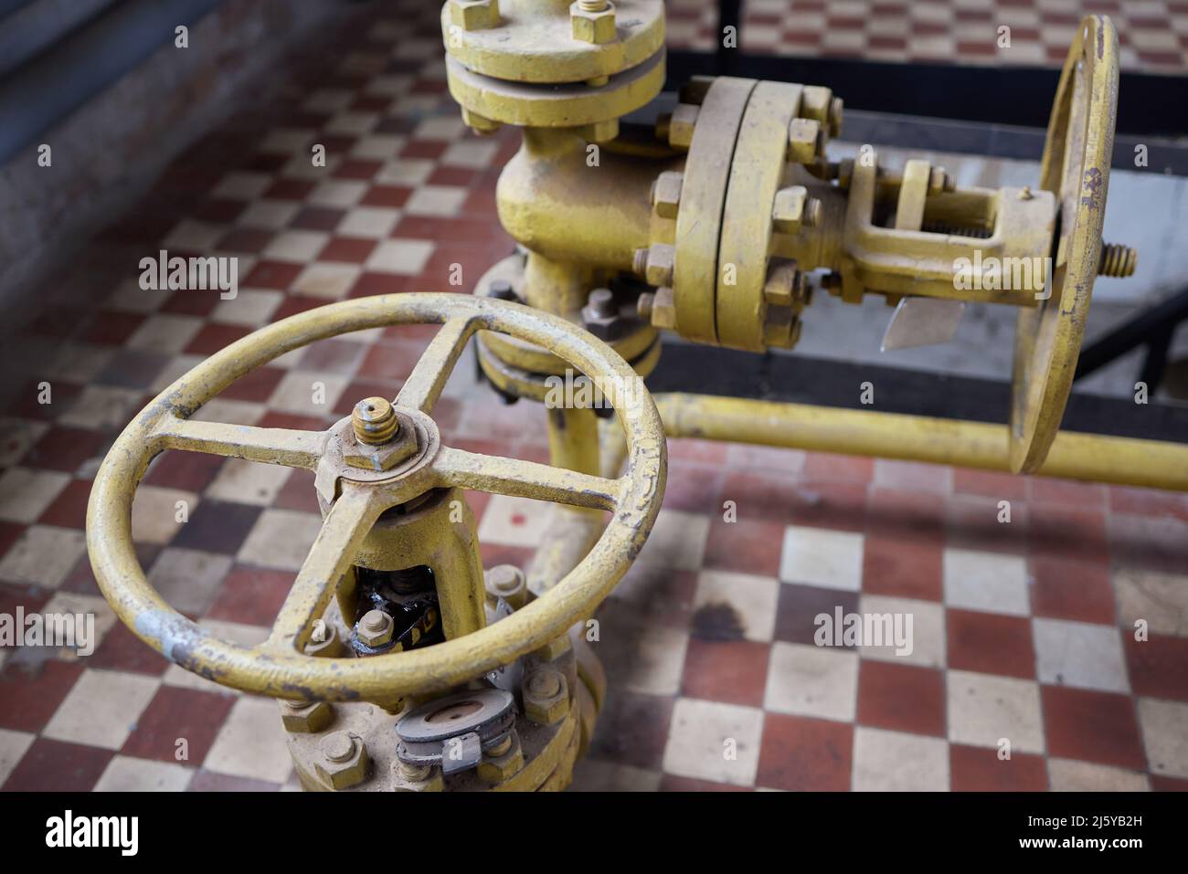 Close-up at pipeline valve which is using to control production process ...