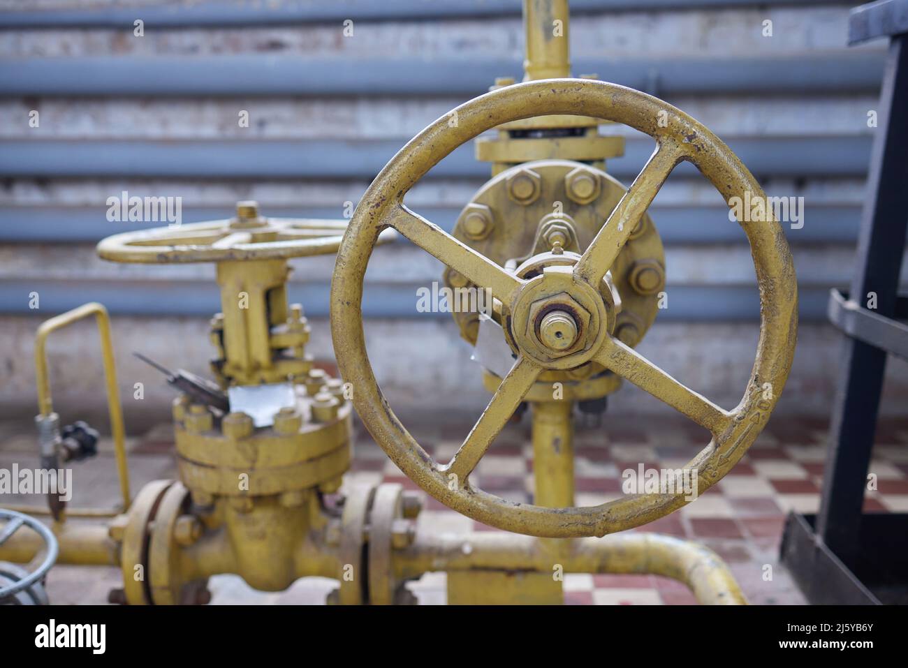 Close-up at pipeline valve which is using to control production process ...
