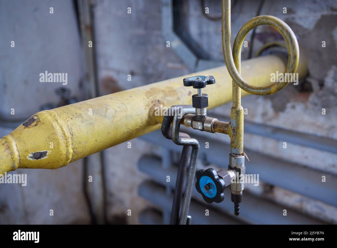 Close-up at pipeline valve which is using to control production process ...