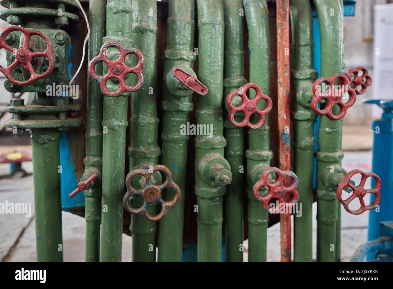Close-up at pipeline valve which is using to control production process ...