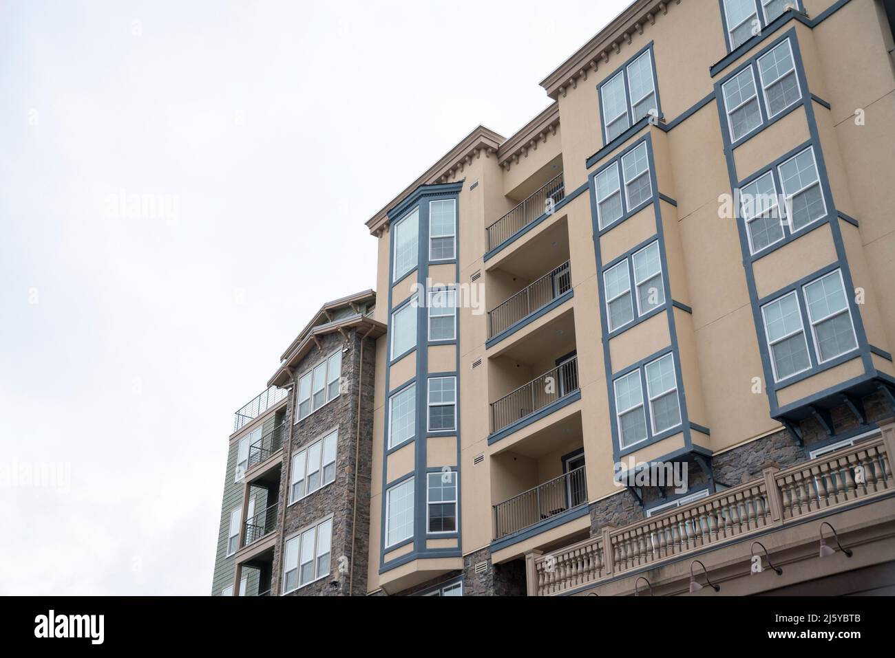 Low-angle view of a mid-rise apartment building with balconies and ...