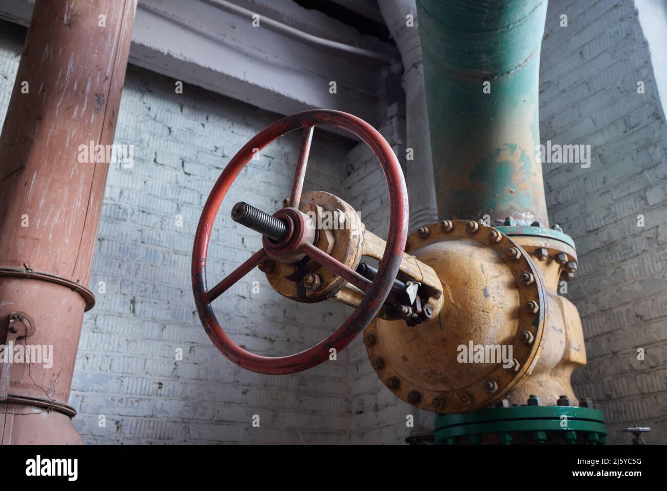 Close-up at pipeline valve which is using to control production process ...