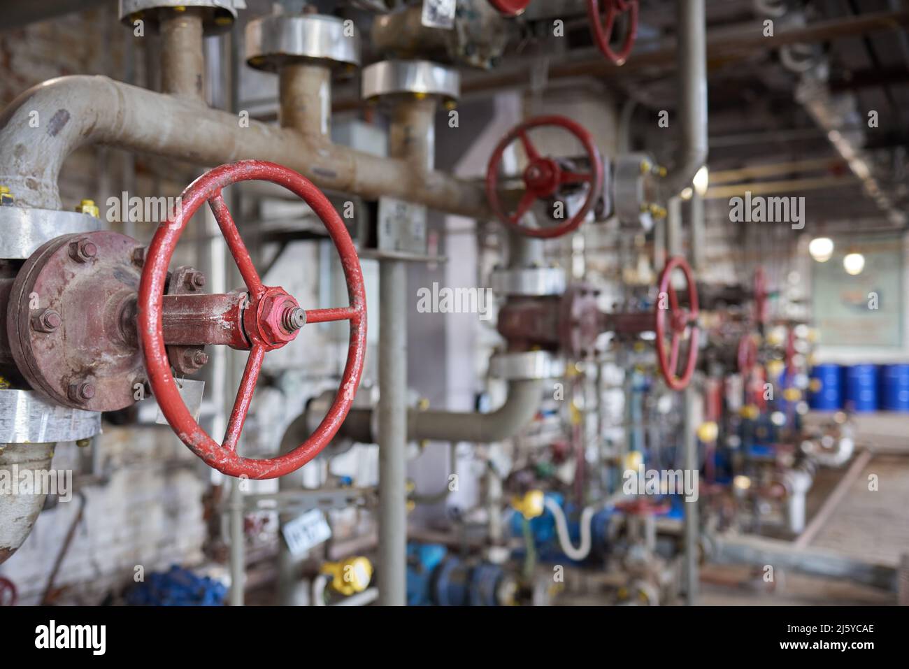 Close-up at pipeline valve which is using to control production process ...