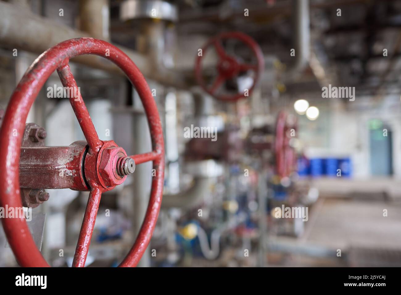 Close-up at pipeline valve which is using to control production process ...