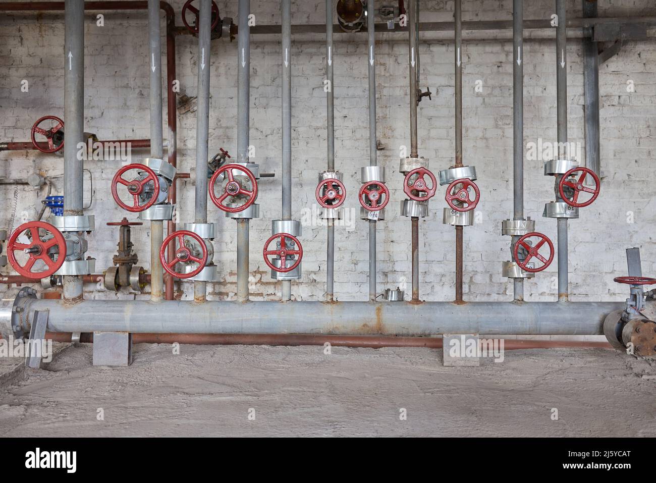 Close-up at pipeline valve which is using to control production process ...