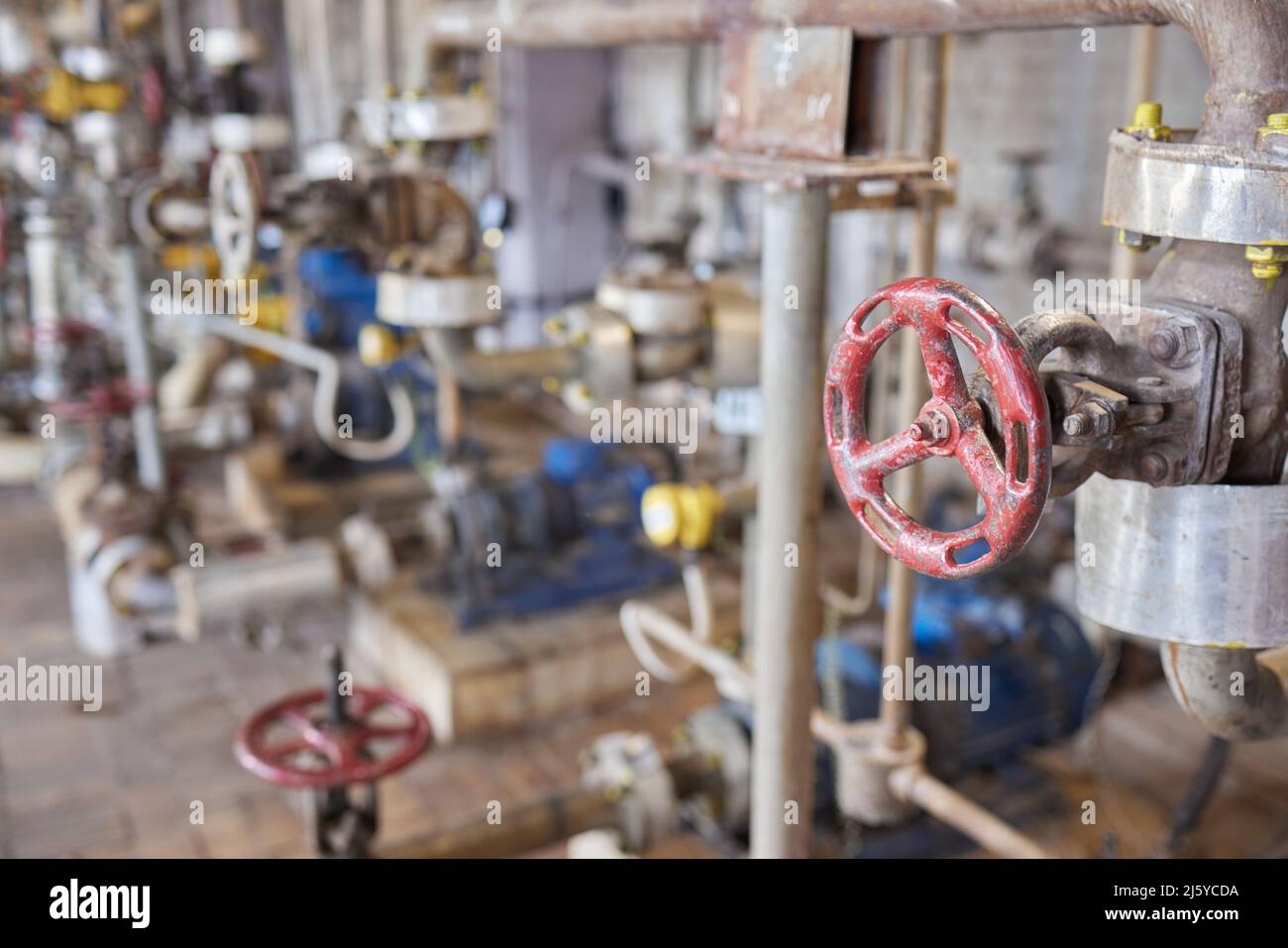 Close-up at pipeline valve which is using to control production process ...