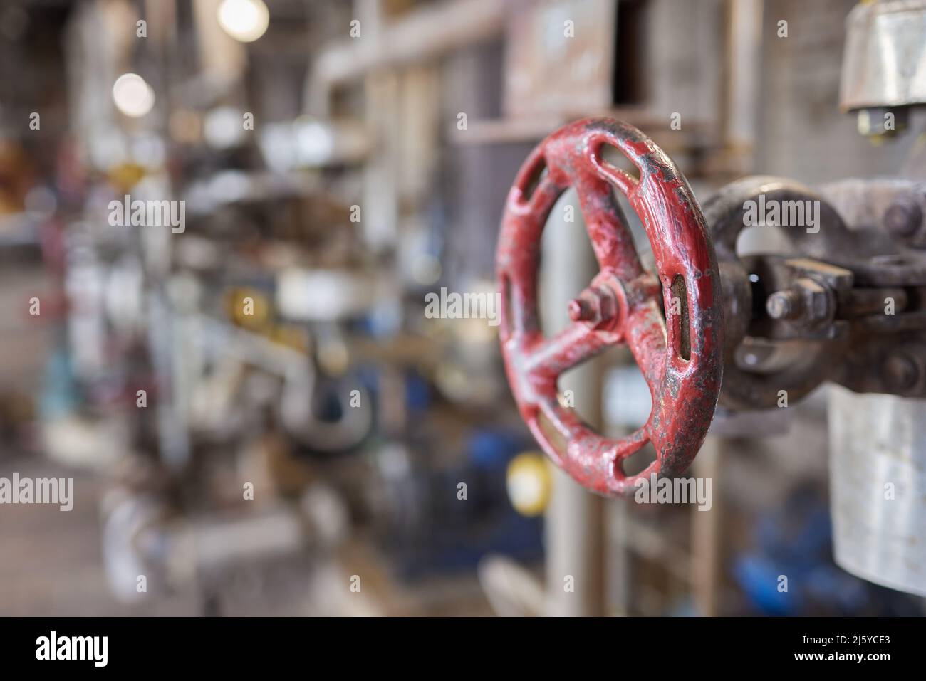 Close-up at pipeline valve which is using to control production process ...