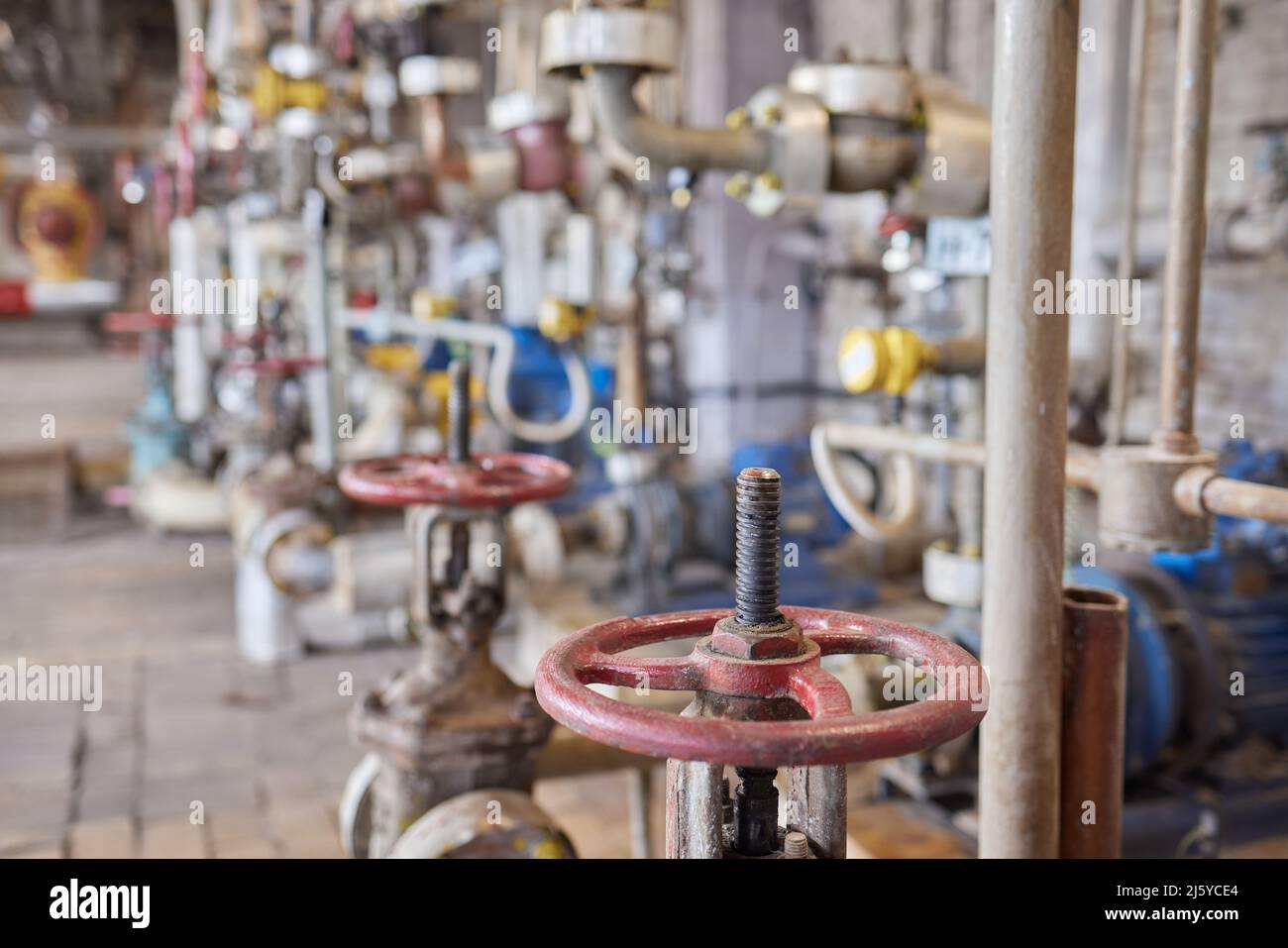 Close-up at pipeline valve which is using to control production process ...