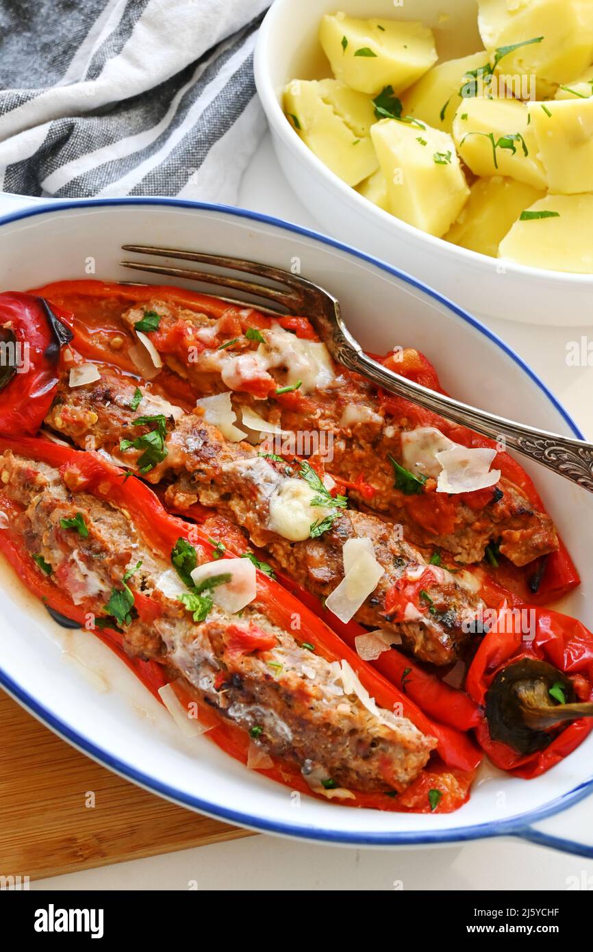 Red pepper stuffed with minced meat in tomato sauce Stock Photo - Alamy