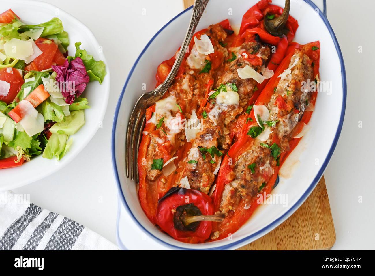 Red pepper stuffed with minced meat in tomato sauce Stock Photo - Alamy