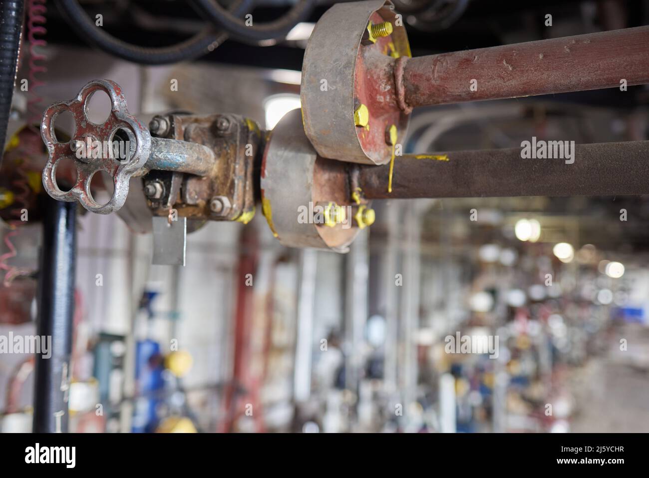 Close-up at pipeline valve which is using to control production process ...