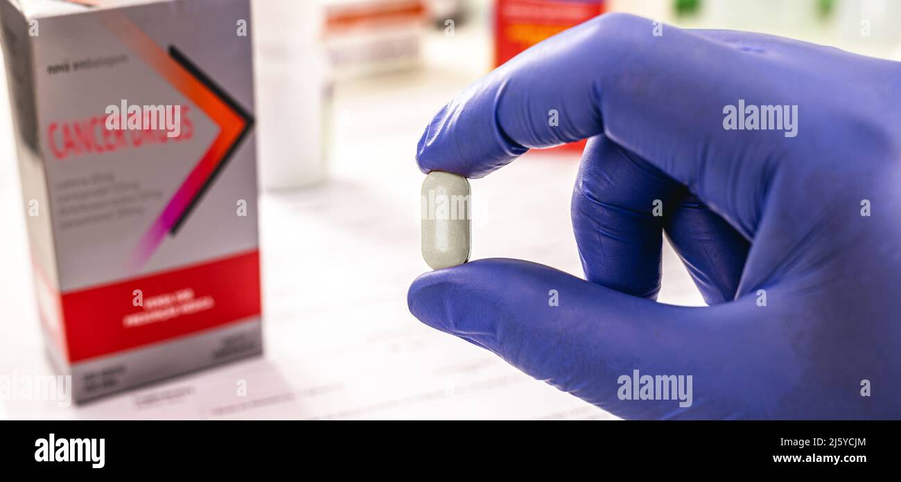pharmacist hand holding pill used in cancer treatment, controlled drug ...