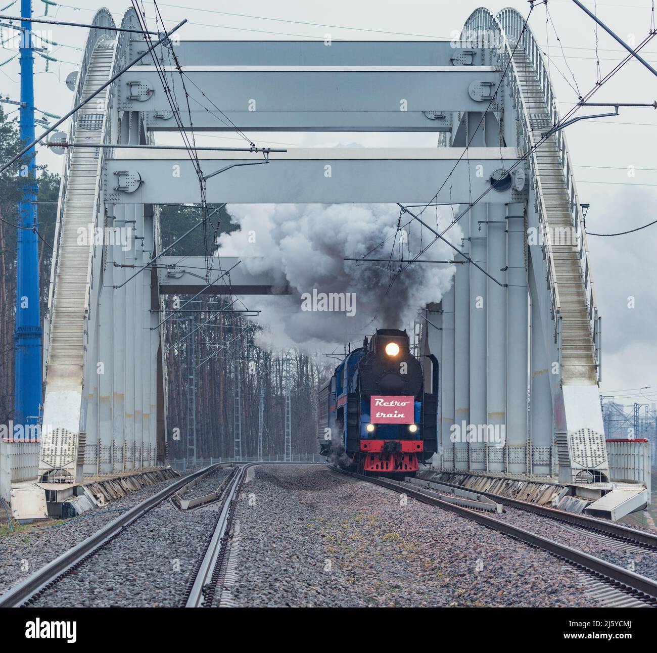 Retro steam train moves through the bridge Stock Photo - Alamy