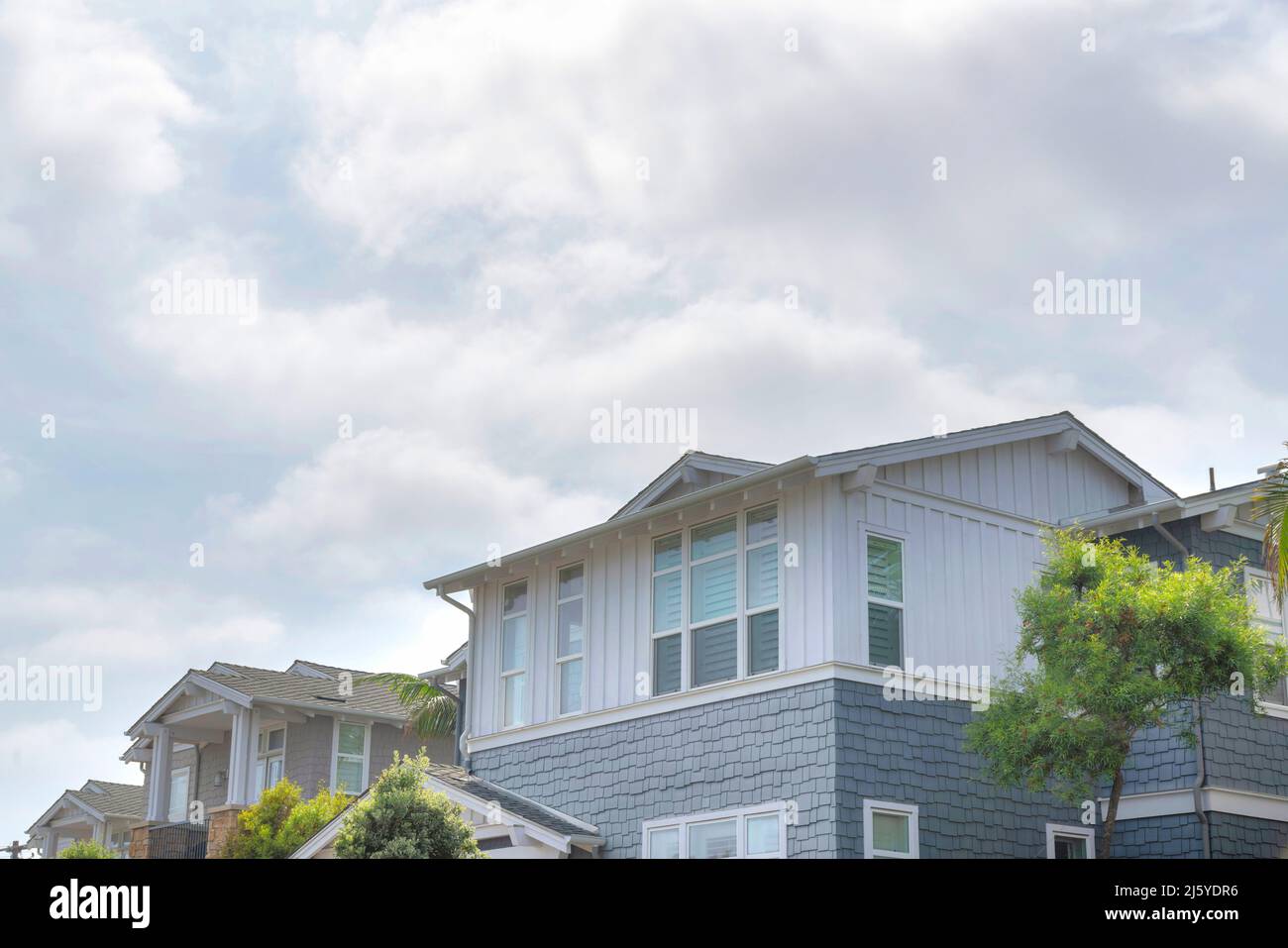 Low angle view of a house with shingles and board and batten sidings at ...