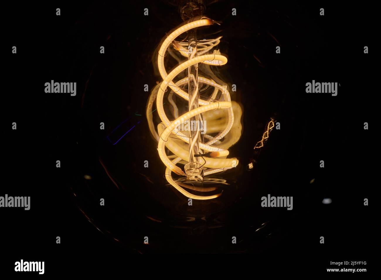 long tube-shaped Edison lamp, bulb, black background Stock Photo - Alamy