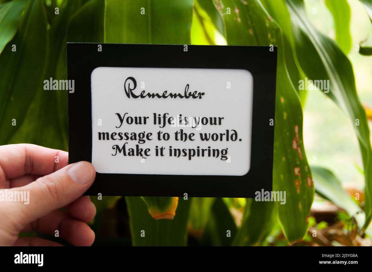 Motivational quote text on notepad - Your life is your message to the ...