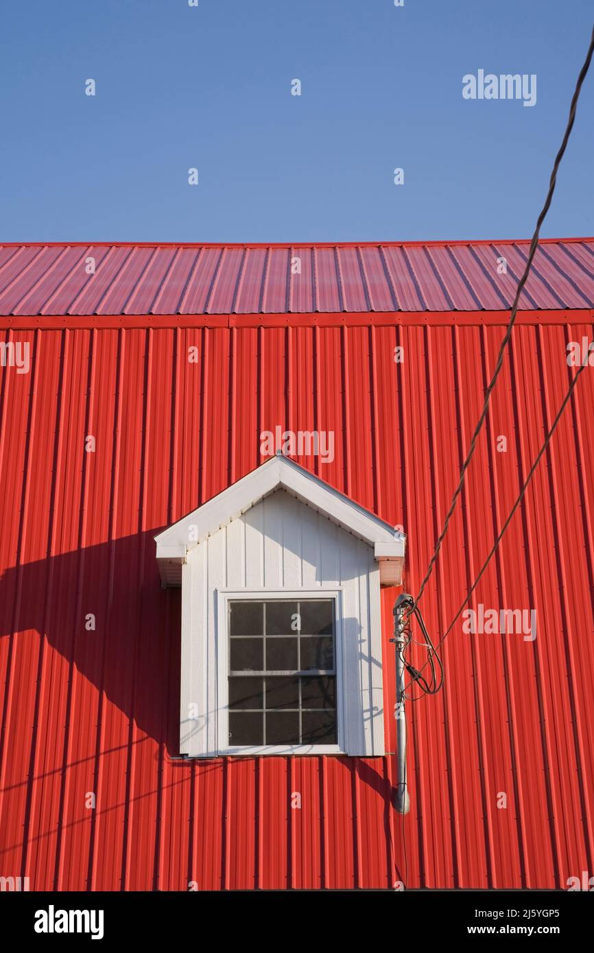 Red metal barn roof with a white dormer window Stock Photo - Alamy