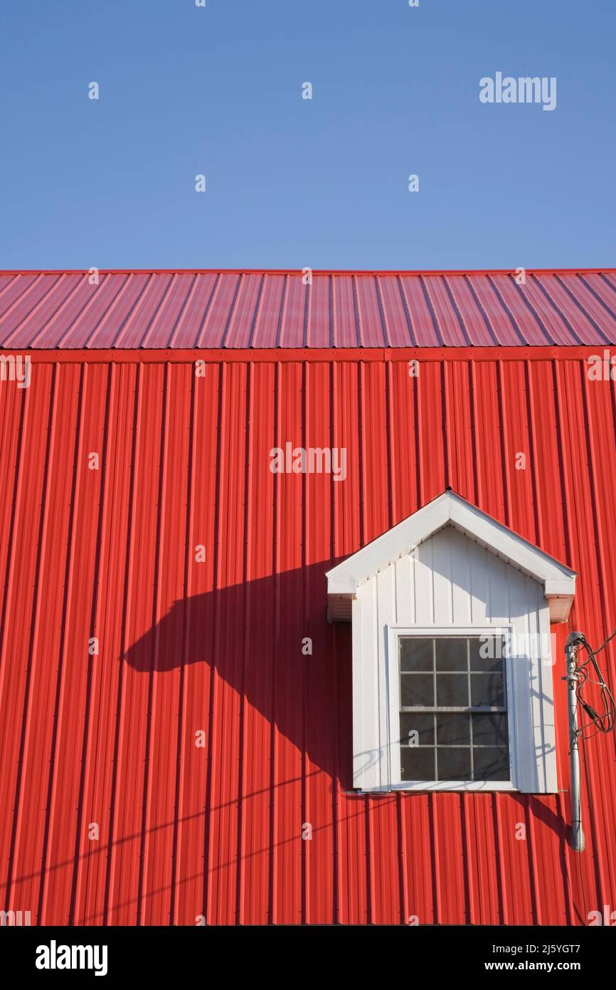 Red metal barn roof with a white dormer window Stock Photo - Alamy