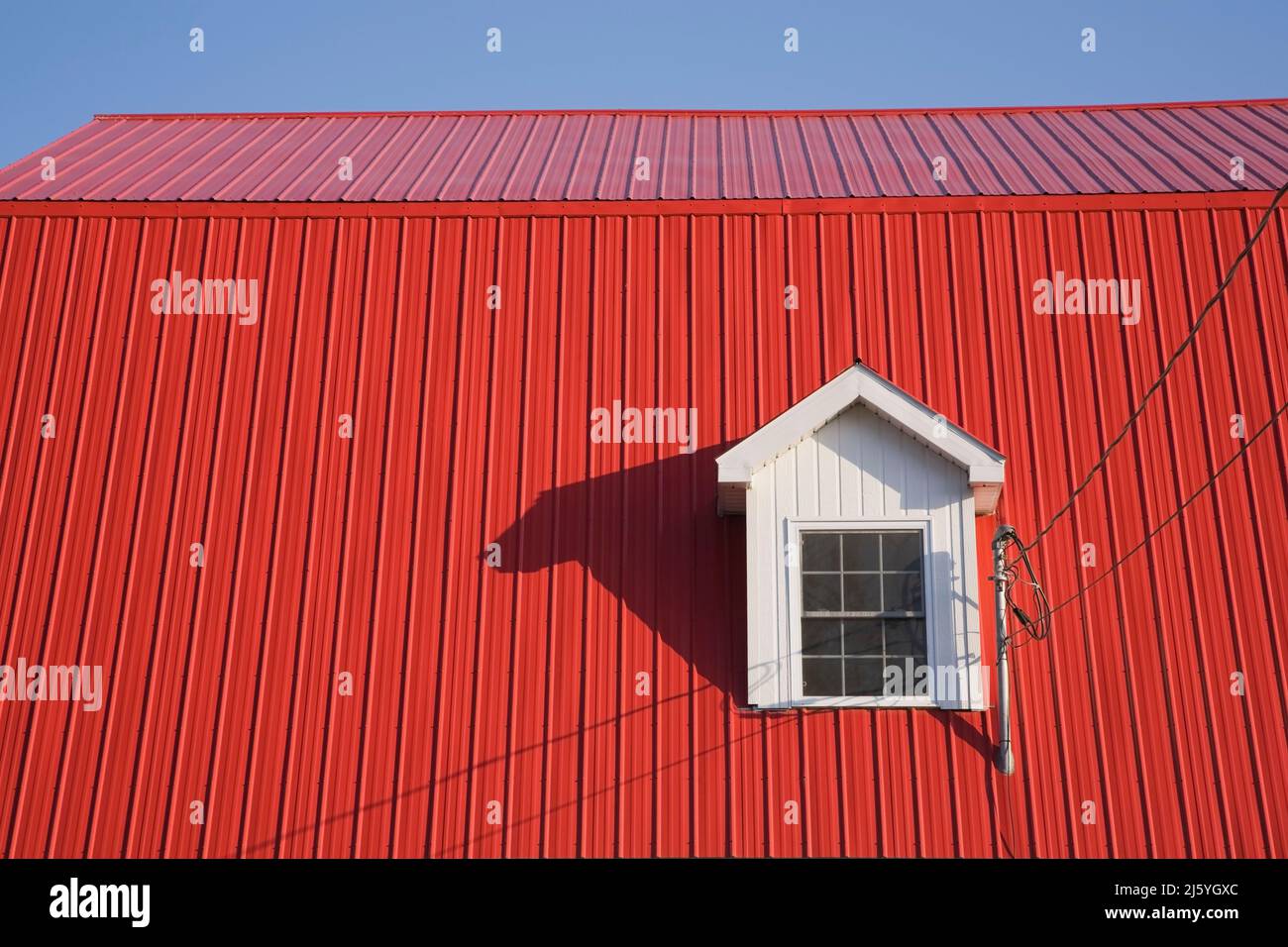 Red metal barn roof with a white dormer window Stock Photo - Alamy