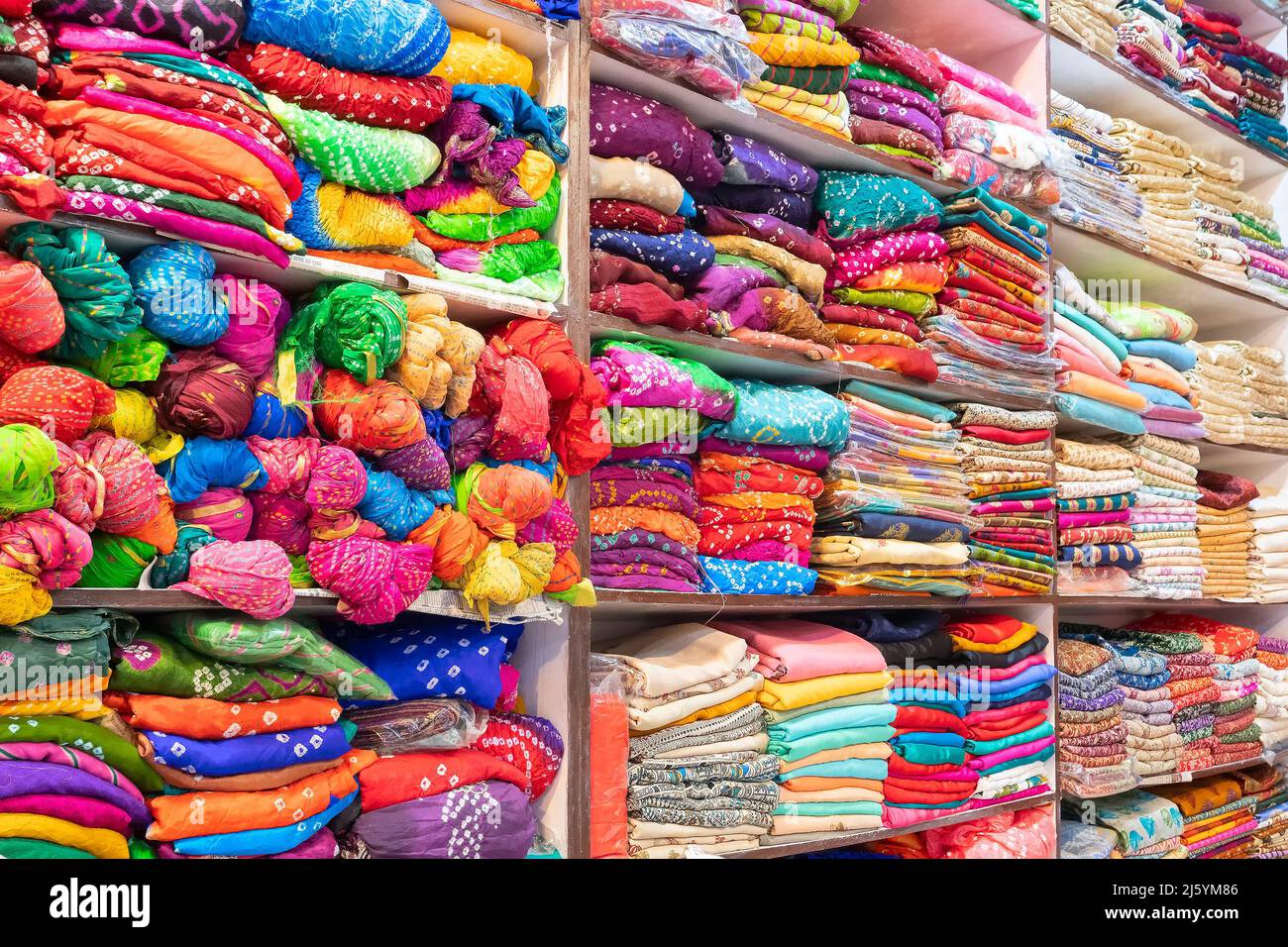 Beautiful colorful Indian sarees are displayed for sale at market place ...