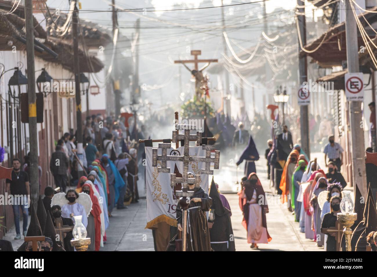 Roman Catholic hooded penitents wearing traditional capirotes, hold a ...