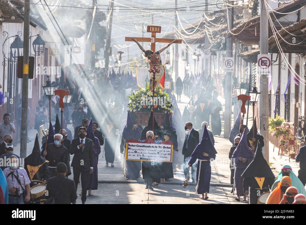Roman Catholic hooded penitents wearing traditional capirotes, hold a ...