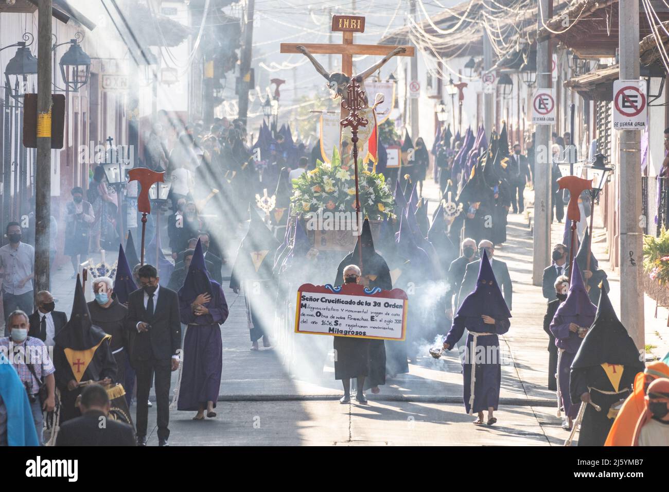 Roman Catholic hooded penitents wearing traditional capirotes, hold a ...