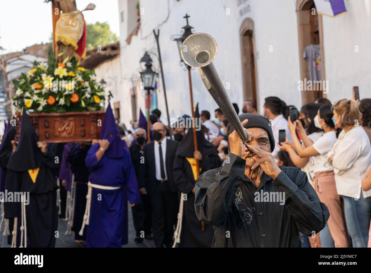 Roman Catholic hooded penitents wearing traditional capirotes, carry a ...
