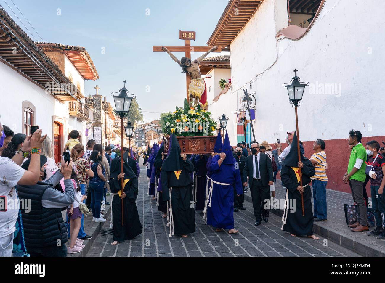 Roman Catholic hooded penitents wearing traditional capirotes, carry a ...
