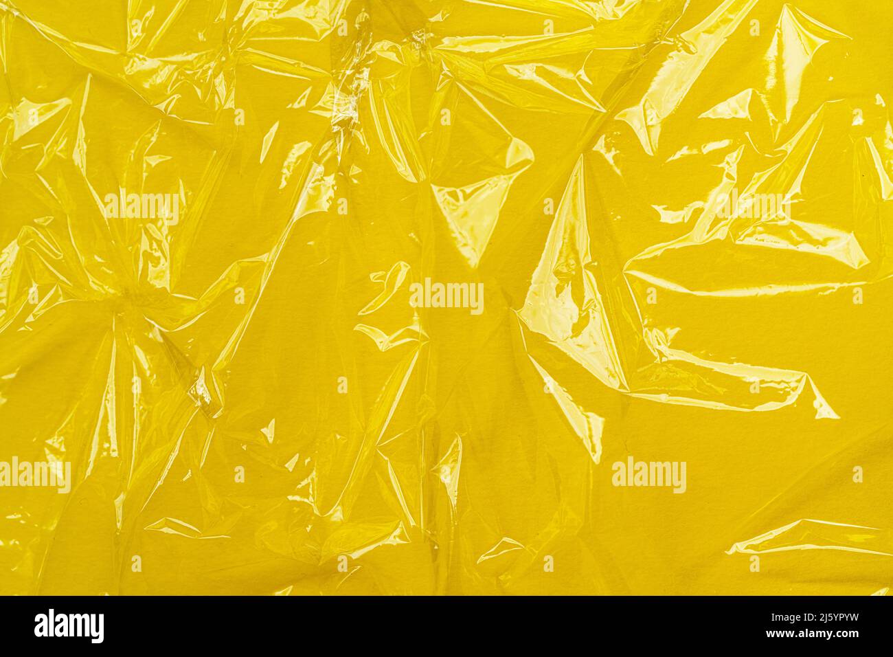 the reflections of light on a crumpled transparent plastic sheet on a ...