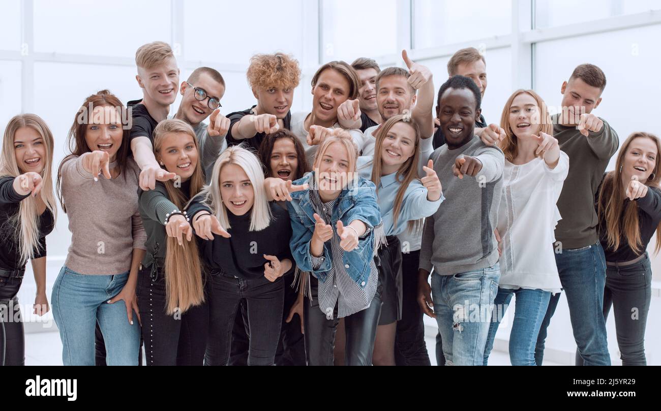 large group of happy young people showing their success. isolated on ...