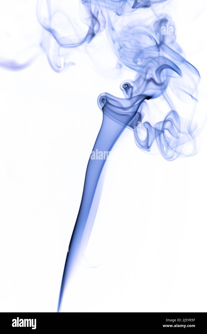 Puffs and curls of dark smoke on a white background rising from a ...