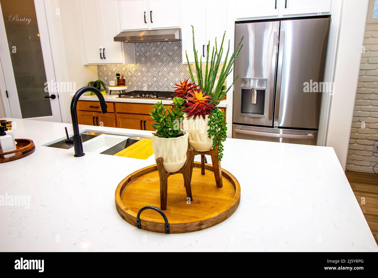 Kitchen Island Counter Top With Tray Of Exotic Flowers Stock Photo - Alamy