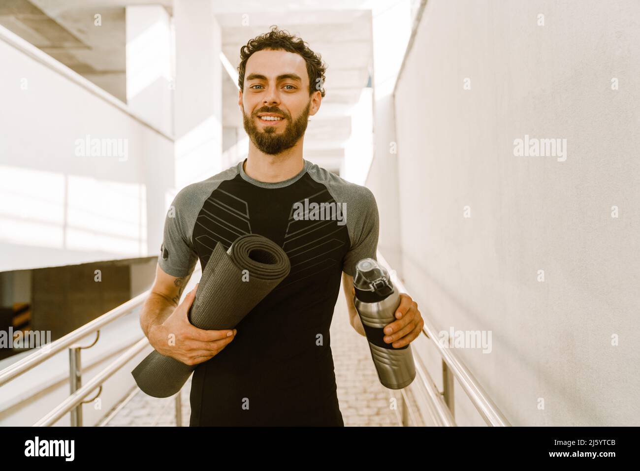Young white man walking with mat while during workout indoors Stock ...