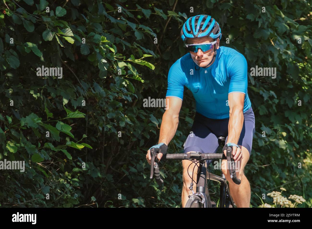 Caucasian male cyclist with professional racing sports gear riding on ...