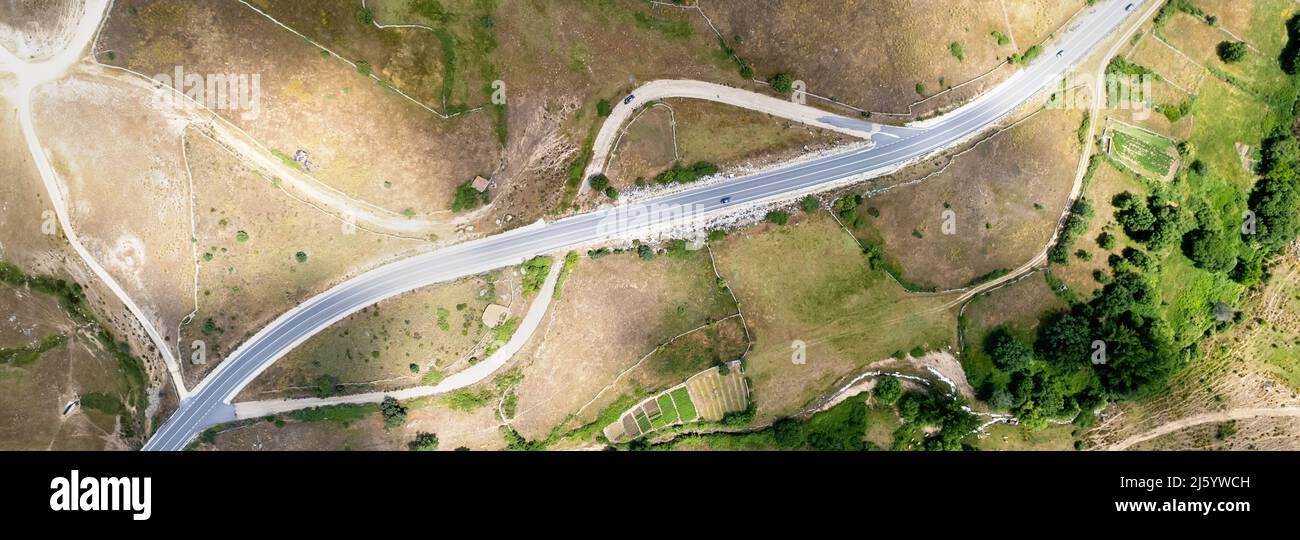 Directly above aerial horizontal view highway surrounded by lands and ...