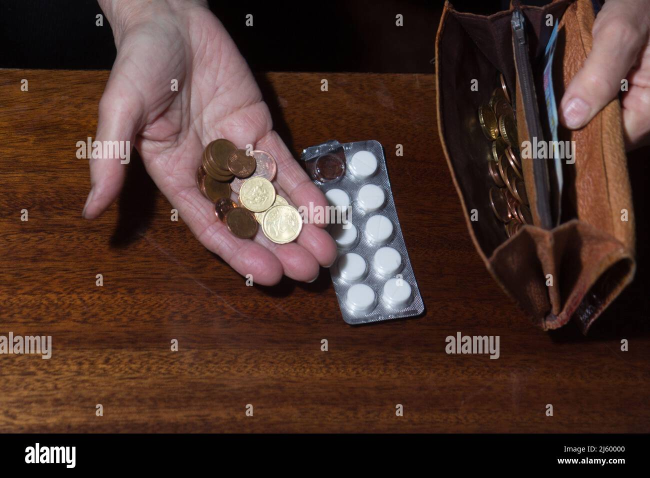 Coins and wallet in the hands of old woman Stock Photo - Alamy