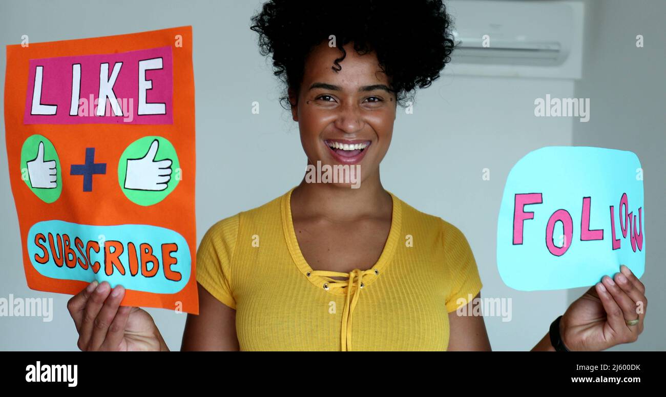 African American female vlogger asking audience to like, subscribe, and ...