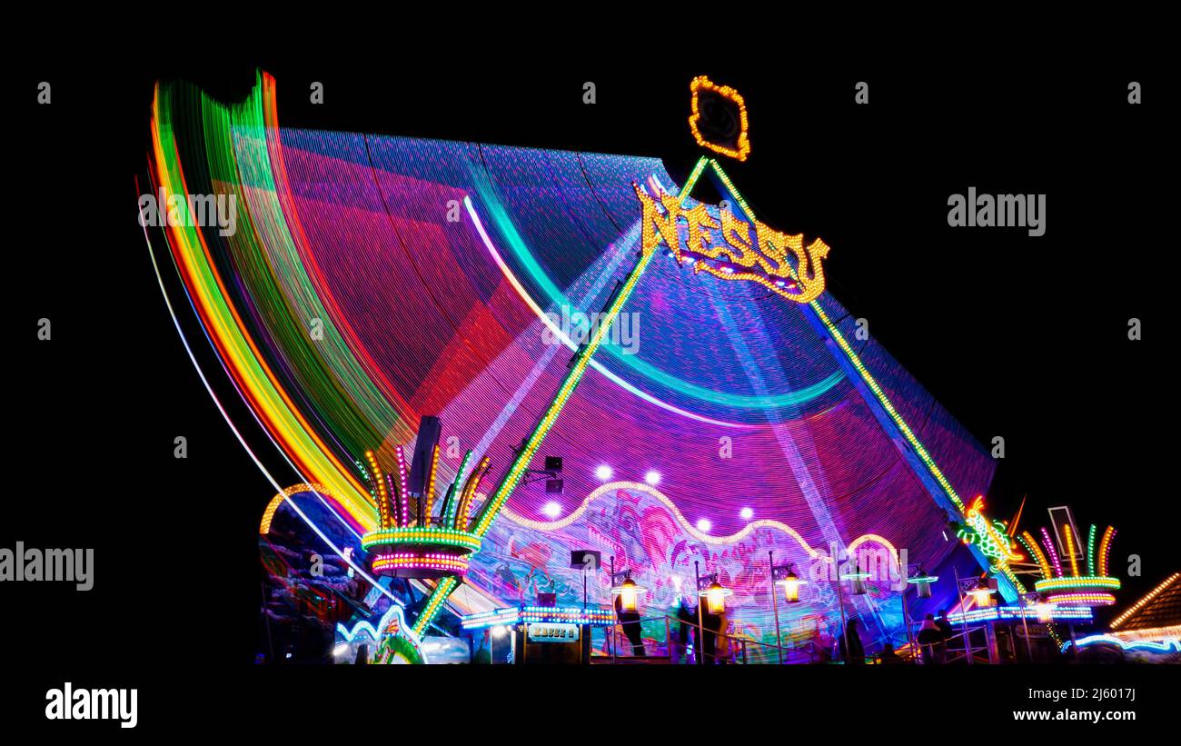 Ship swing on funfair at night in motion blur Stock Photo - Alamy