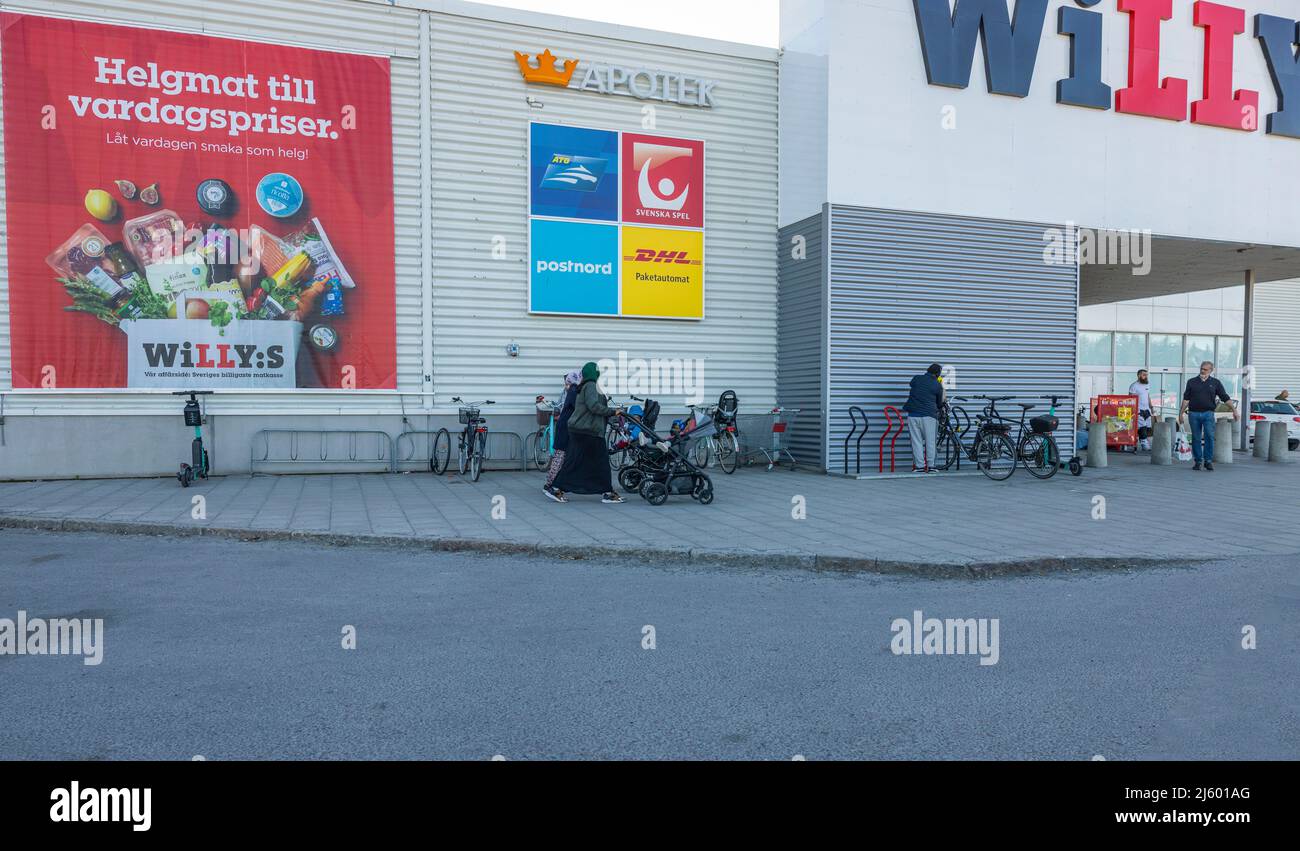 Beautiful view of facade of Willy:s supermarket with people passing by ...