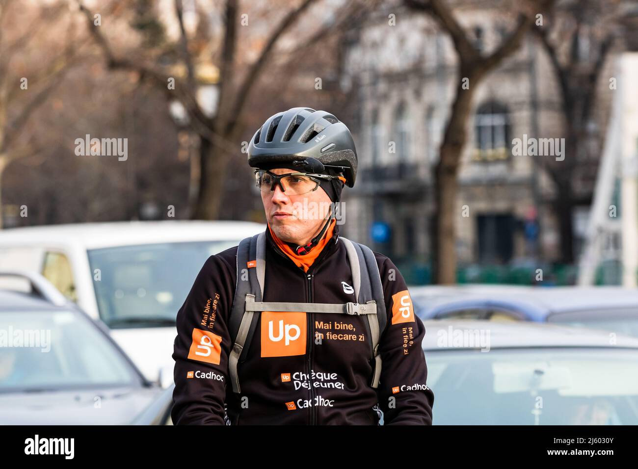 Riding a bicycle on the city streets. Commute to work in Bucharest ...