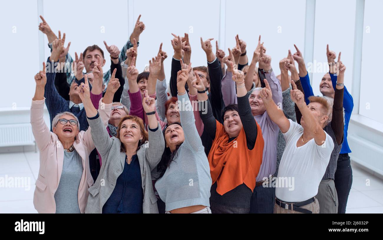 a group of elderly people raised their hands up Stock Photo - Alamy