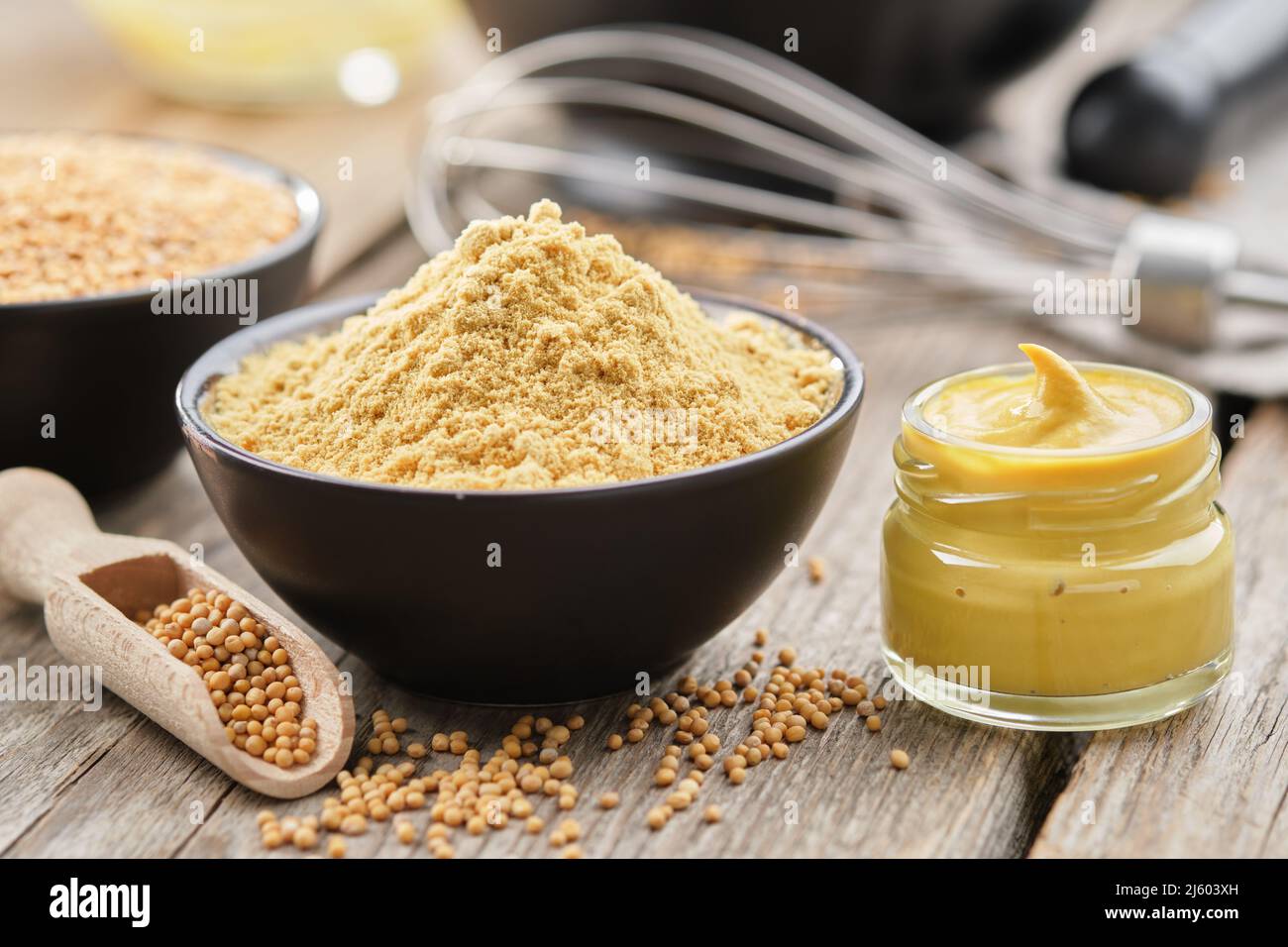 Mustard sauce jar and bowl of powdered mustard seeds. Scoop of whole ...