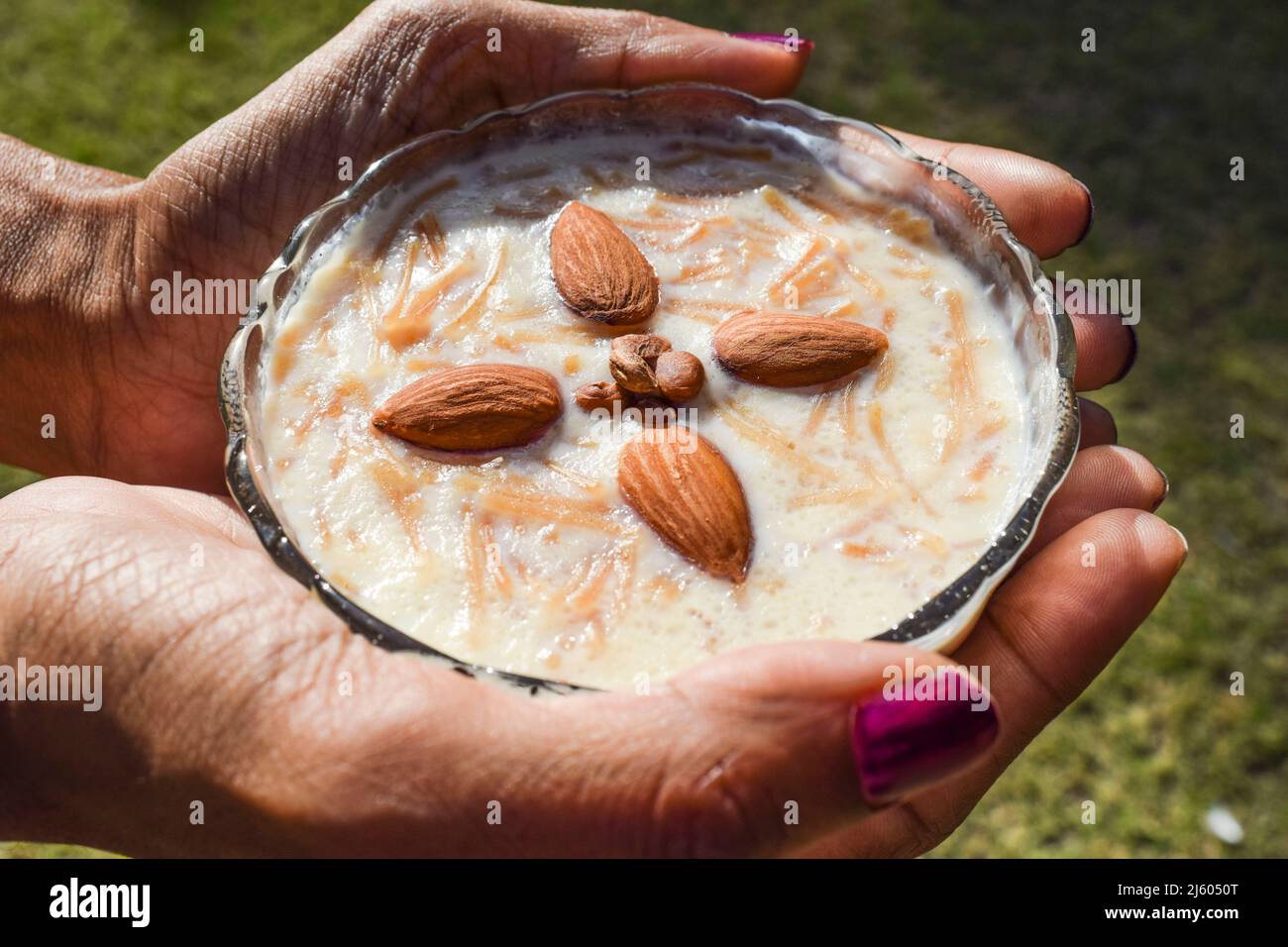 Female holding bowl of Delicious Dessert from India and Pakistan served ...