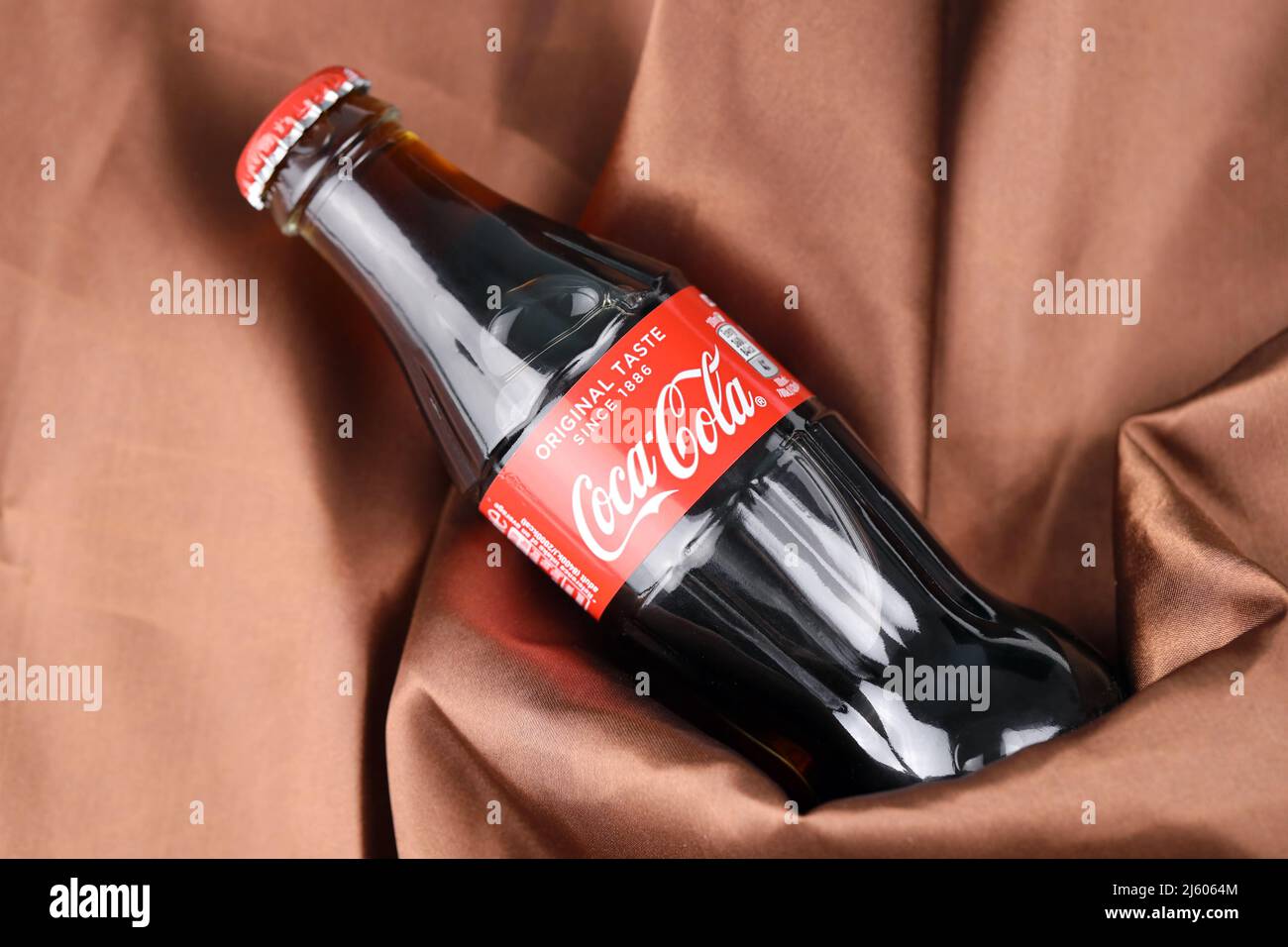 KHARKIV, UKRAINE - DECEMBER 16, 2021: Coca Cola production with classic ...