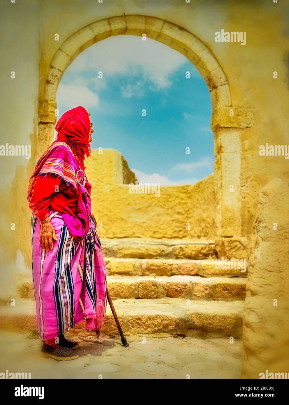 Hale and hearty mature woman in national dress with cane and head ...